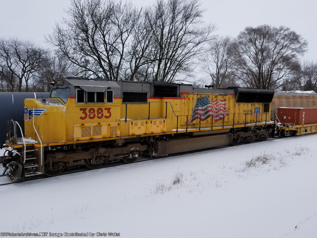 UP# 3883 passes a east bound at Rochelle.